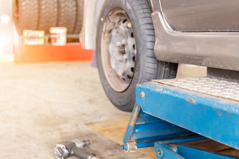 Mechanic Fixing the Wheel Alignment Device Onto a Car Wheel of New Tire ...