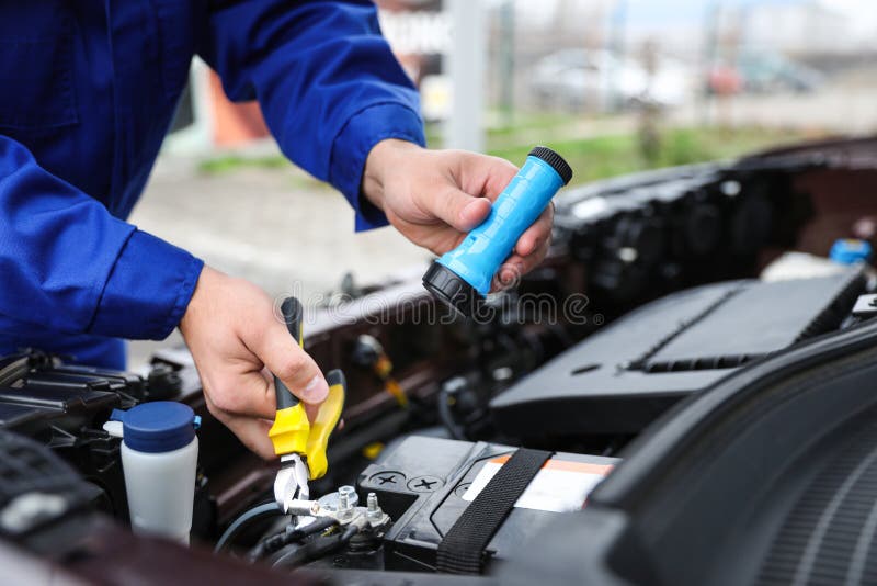 Mechanic with Flashlight Fixing Car Outdoors Stock Photo - Image of ...