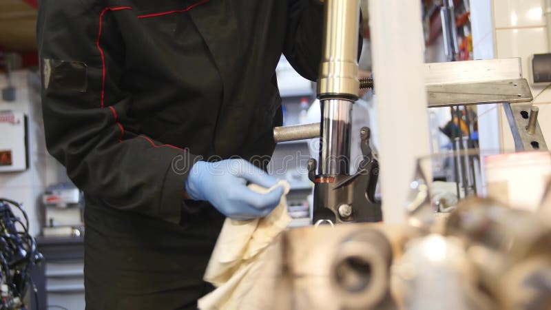 Mechanic in Garage with Old Shock Absorber Stock Image - Image of ...