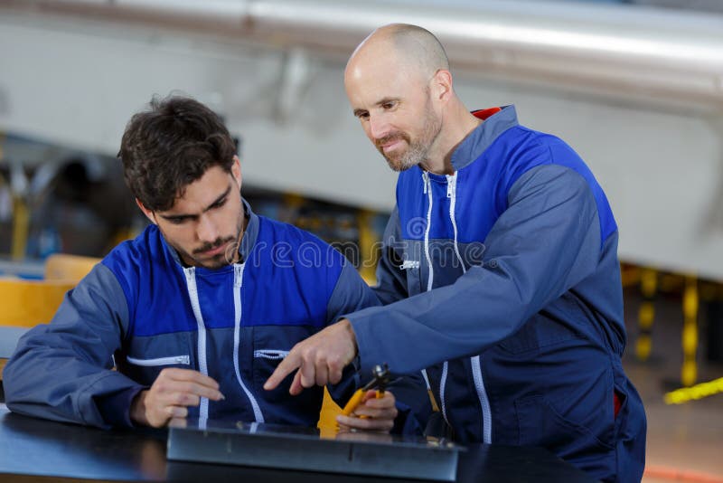 Mechanic Giving Instructions To Apprentice Stock Photo - Image of ...