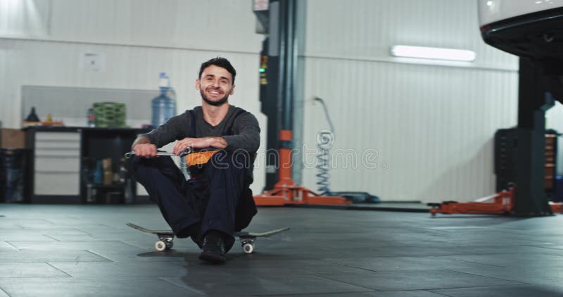 Mechanic Guy Smiling and Attractive in a Uniform in Front of the Camera ...