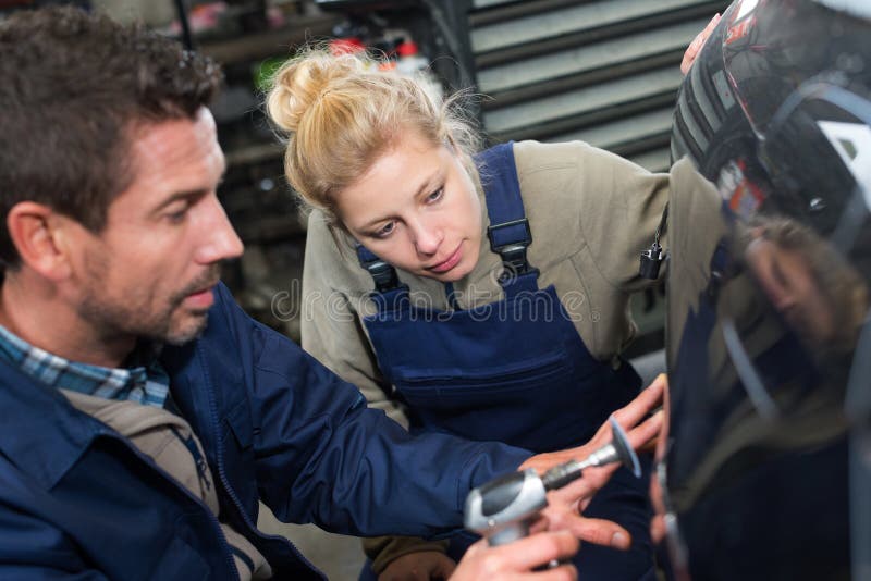 Mechanic and Young Apprentice Working on Car Dent Stock Photo - Image ...