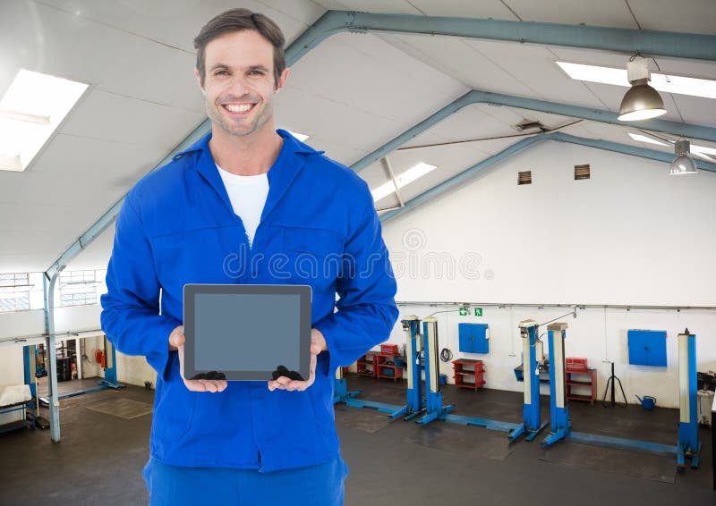 Mechanic Holding a Digital Tablet Against Digital Interface in Workshop ...