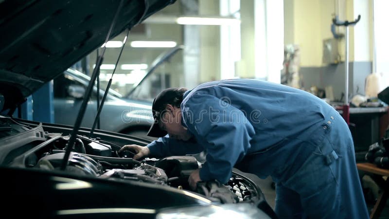 Mechanic Inspecting Engine Cylinders and Pistons Using Borescope Camera ...