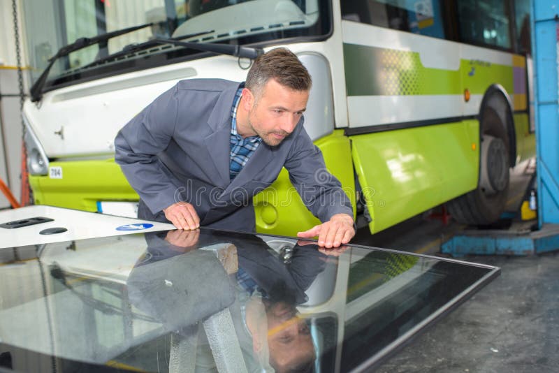 Mechanic Inspecting New Panel for Bus Stock Image - Image of mechanic ...