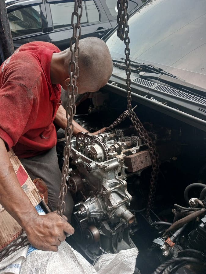 A Mechanic is Installing an Engine in a Car Editorial Stock Image ...