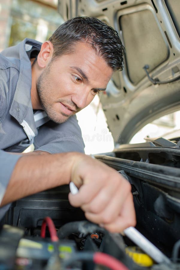 Mechanic Looking at Car Engine Stock Image - Image of hood, filter ...