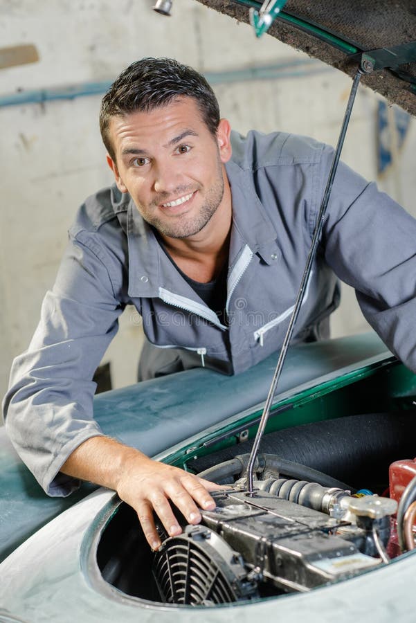 Mechanic Looking in Engine Bay Stock Photo - Image of motor, garage ...