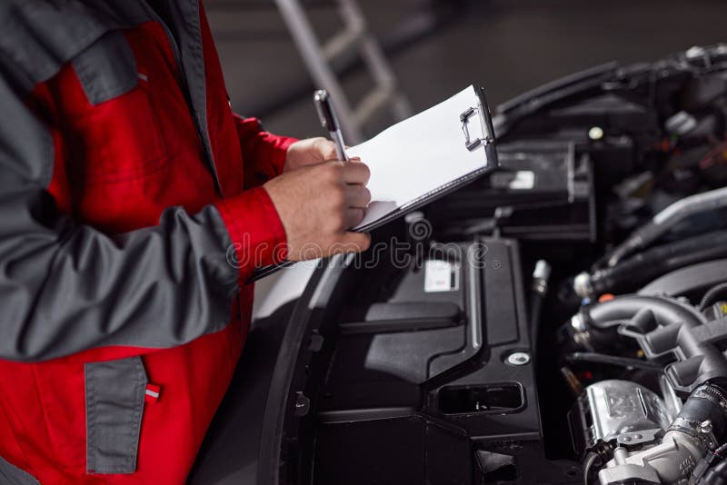 Mechanic Making Notes on Clipboard Near Car Stock Photo - Image of ...
