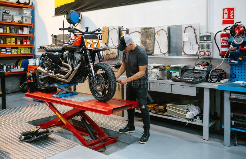 Mechanic Man Checking Custom Motorcycle Over Platform Stock Image ...