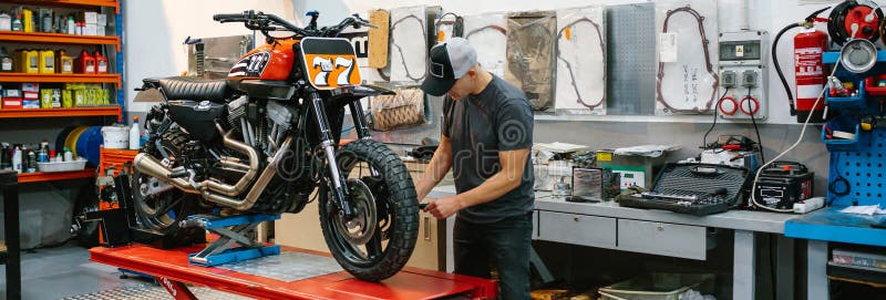 Mechanic Man Checking Custom Motorcycle Over Platform Stock Image ...