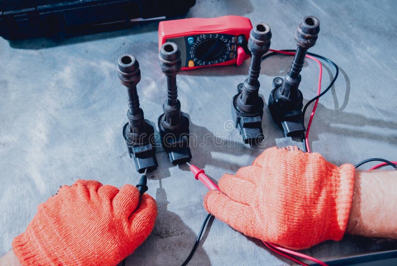 Mechanic Man with Digital Multimeter Testing Ignition Coil Stock Photo ...