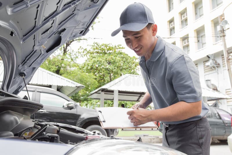 Mechanic Man Holding Clipboard and Check the Car Stock Image - Image of ...