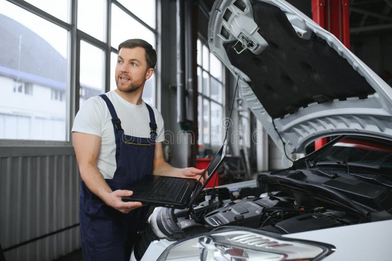 Mechanic Man Mechanic Manager Worker Using a Laptop Computer Checking ...