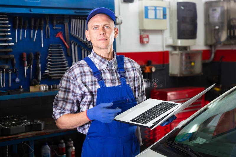 Mechanic Man Using Laptop Checking Car in Workshop Stock Image - Image ...