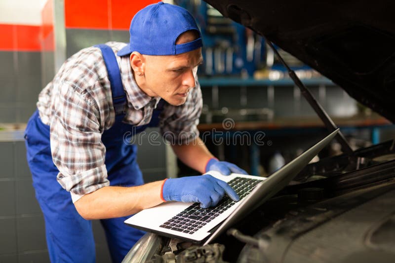 Mechanic Man Using Laptop Checking Car in Workshop Stock Image - Image ...
