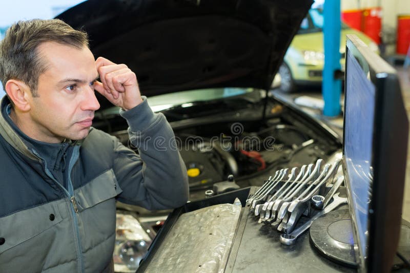 Mechanic Man with Wrench Repairing Car at Workshop Stock Photo - Image ...