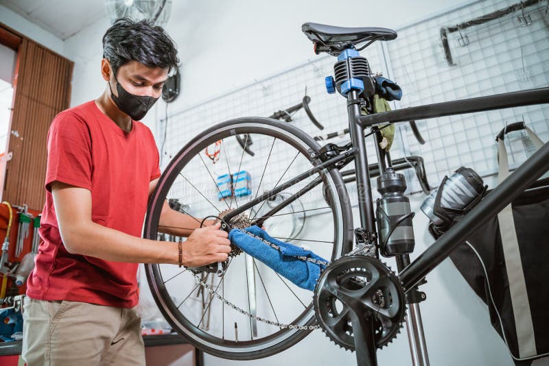 A Mechanic in Mask Working Tighten the Bicycle Axle with a Wrench Stock ...
