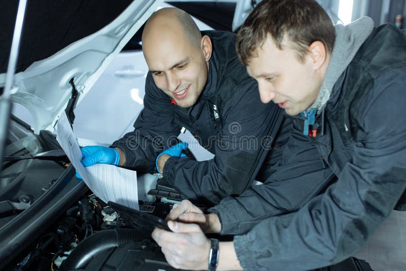 Mechanic Men with Wrench Repairing Car at Workshop. Stock Photo - Image ...