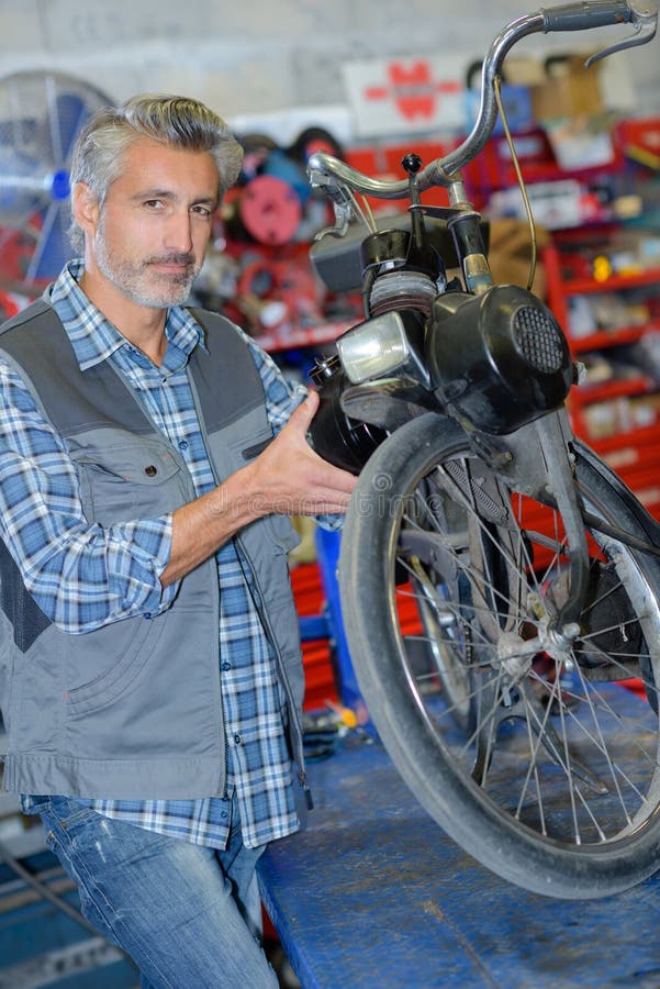 Mechanic with Motorized Bicycle Stock Image - Image of bike, workbench ...