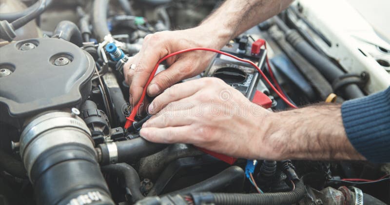 Mechanic with a Multimeter Testing Car Engine. Car Service Stock Image ...