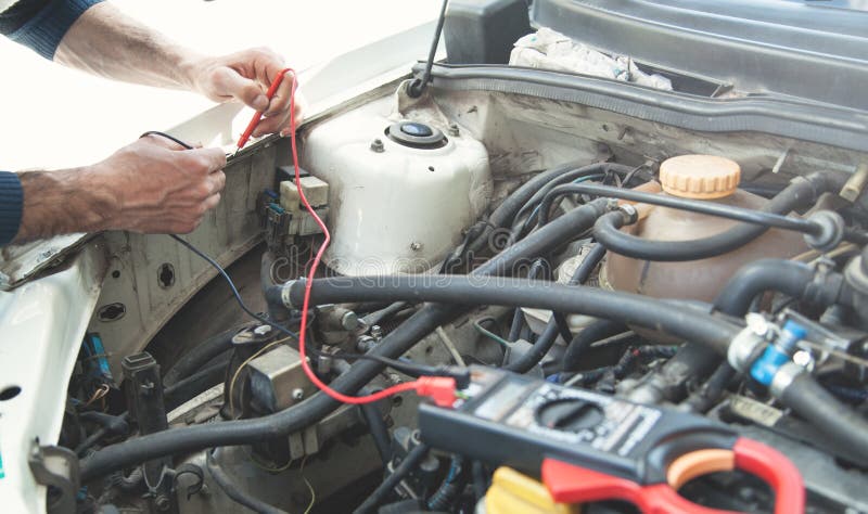 Mechanic with a Multimeter Testing Car Engine. Car Service Stock Photo ...