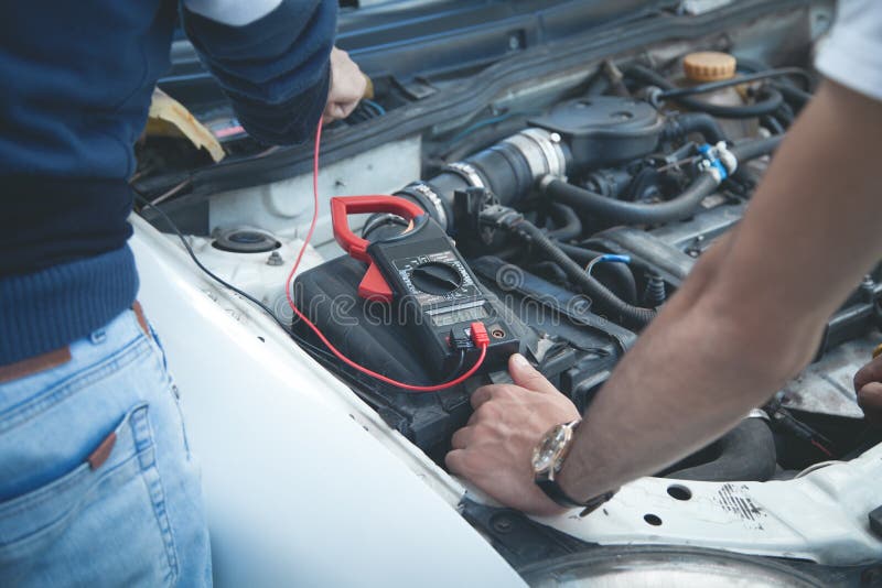 Mechanic with a Multimeter Testing Car Engine. Car Service Stock Image ...