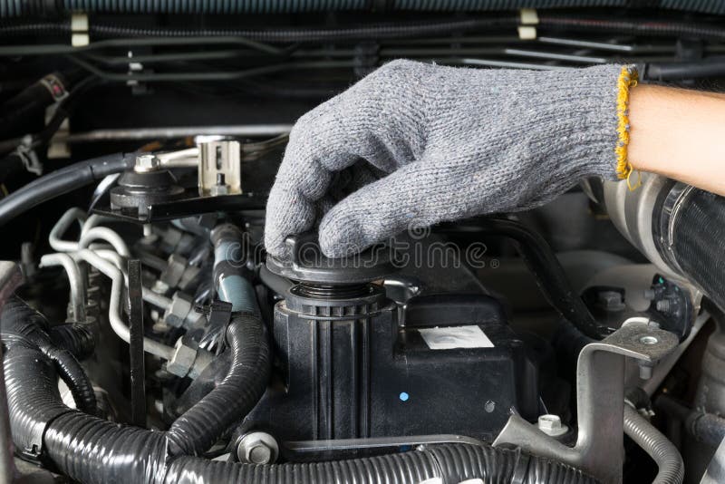 A Mechanic is Opening the Oil Cap from a Car Engine. Stock Image ...