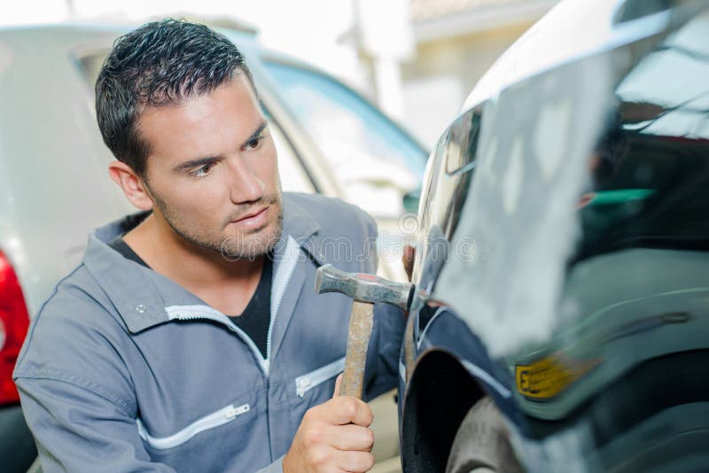 Mechanic panel beating car stock image. Image of handsome - 88083551