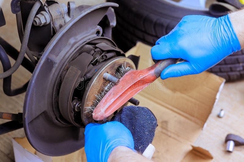 Mechanic Performs Brake Maintenance on Car in a Workshop during Daytime ...