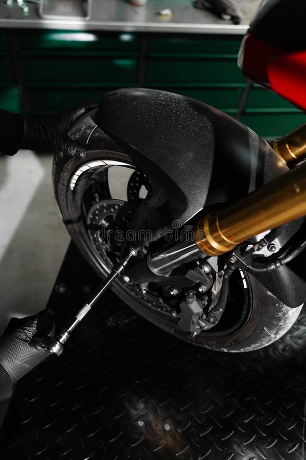 Mechanic Performs Front Suspension Service on Motorcycle, Adjusting ...