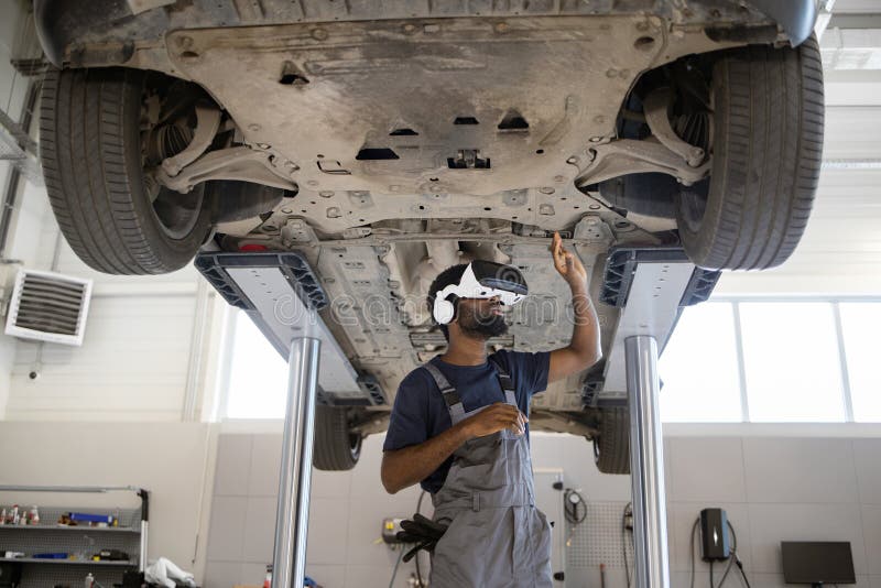 Mechanic Performs Virtual Car Inspection with Advanced Technology Stock ...