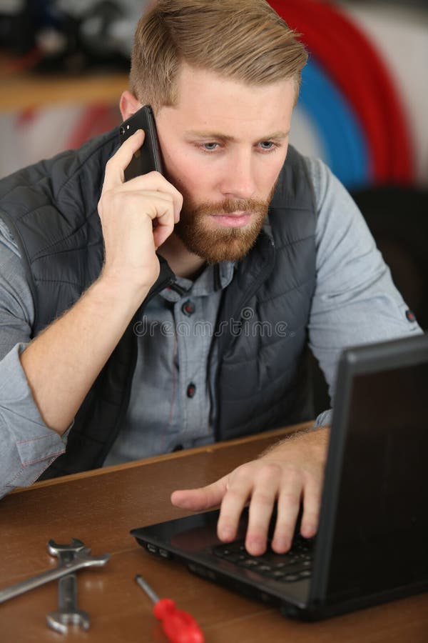 Mechanic on the phone stock photo. Image of male, head - 22207794