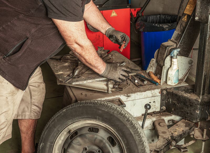 Mechanic Picks Up a Tool To Remove the Valve of a Car Stock Photo ...