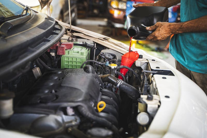 Mechanic Pouring Oil into Car Engine Stock Photo - Image of maintenance ...