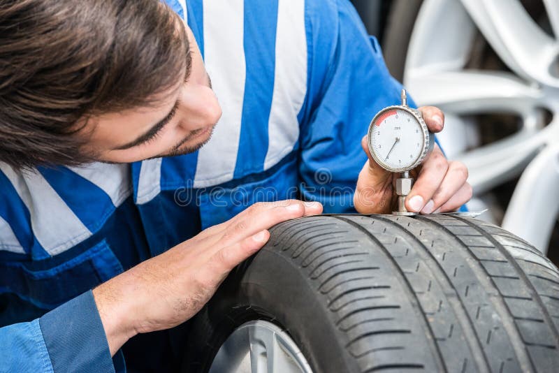 Mechanic Pressing Gauge Tire Tread To Measure Its Depth Stock Photos ... Mechanic Pressing Gauge Tire Tread To Measure Its Depth Stock Photos ...