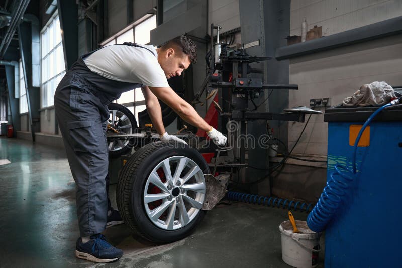 Professional Worker Checking Technical Condition of Car Wheel Stock ...