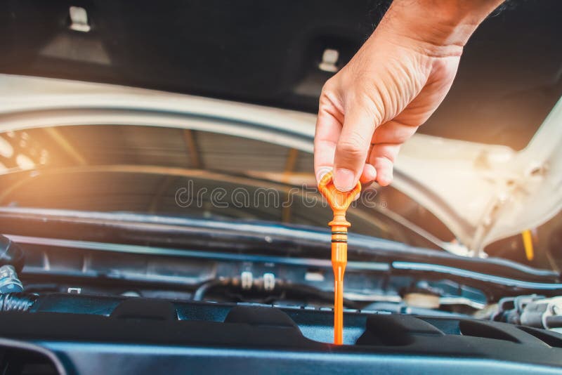 The Mechanic is Pulling the Dipstick in the Engine Compartment To Check ...