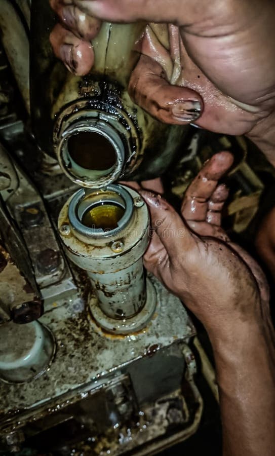 Mechanic Puts Oil into the Engine from a Jerry Can Stock Photo - Image ...