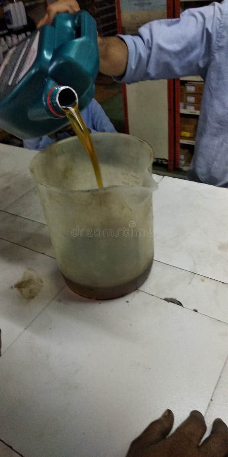 Mechanic Putting Engine Oil in a Jar Stock Photo - Image of mechanic ...