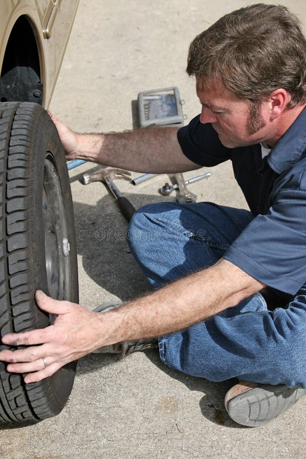 Mechanic Removing Tire stock image. Image of garage, automobile - 632479