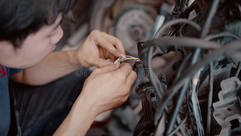 Mechanic Repair or Wiring Motorcycle in Garage. Repair or Maintenance ... Mechanic Repair or Wiring Motorcycle in Garage. Repair or Maintenance ...