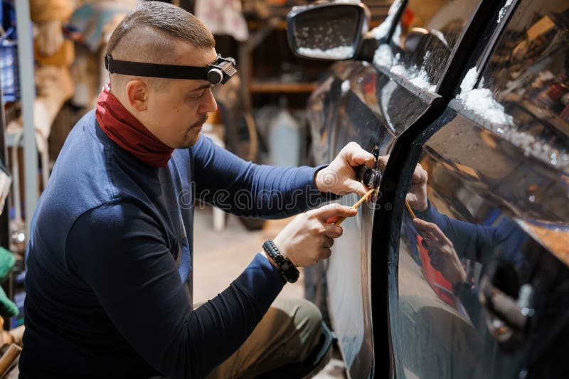 Mechanic Repairing Car Door Lock in Workshop Stock Image - Image of ...