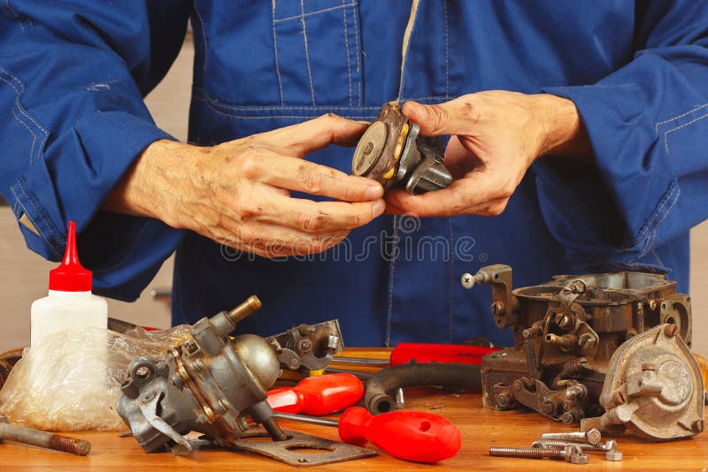 Mechanic Repairing Parts of the Automobile Engine in Workshop Stock ...
