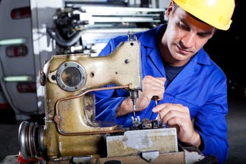Mechanic Repairing Sewing Machine Stock Image - Image of studio, helmet ...
