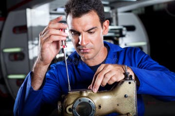 Mechanic Repairing Sewing Machine Stock Photo - Image of industry ...