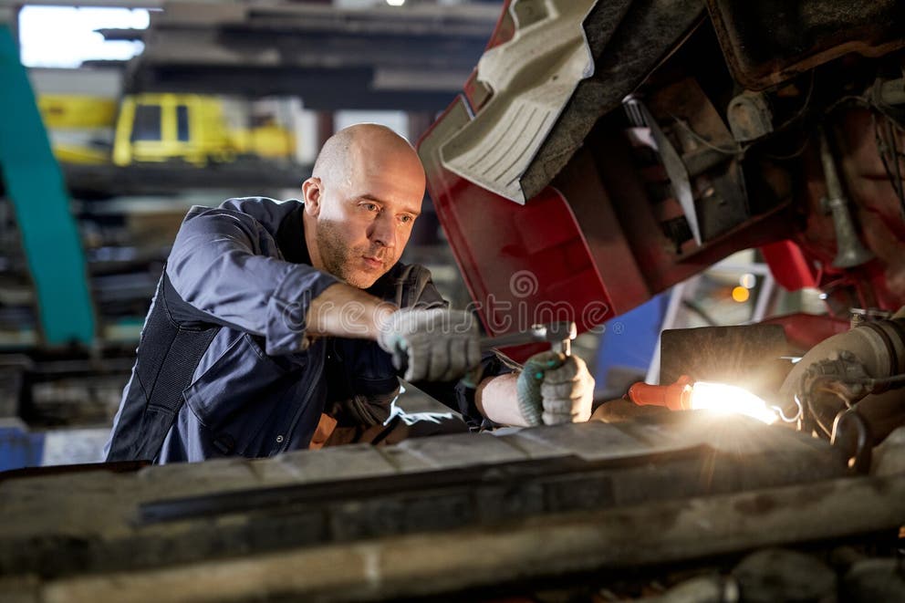 Mechanic Repairing Vehicle Engine in Workshop Setting Stock Image ...