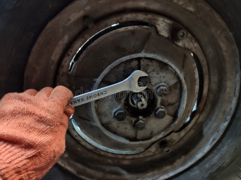 A mechanic repairs a wheel stock photo. Image of engine - 269477240