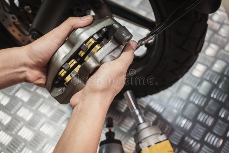 Mechanic Replace and Adjust Motorcycle Brake System in Garage ...