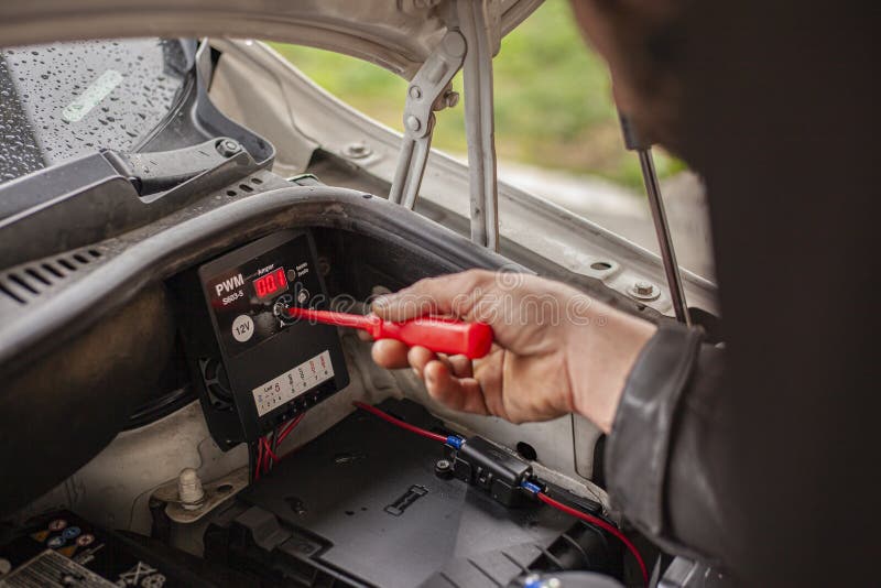 Mechanic`s Hands Adjust the Hydrogen System Control Unit in the Car ...